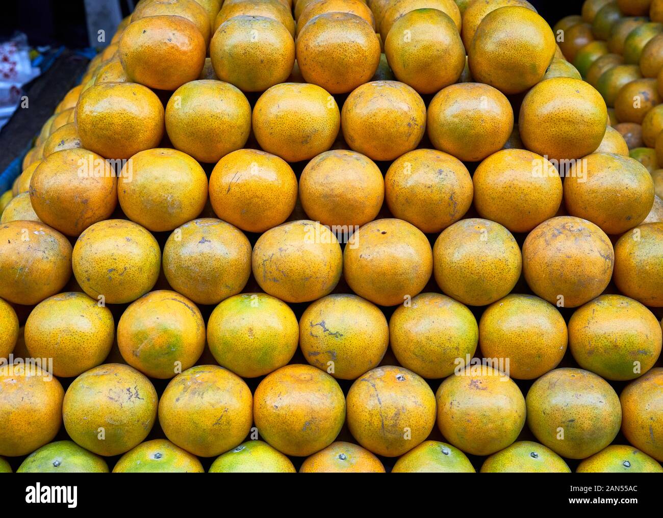 Fresh juicy oranges built like a pyramid at a market in Bangkok ...