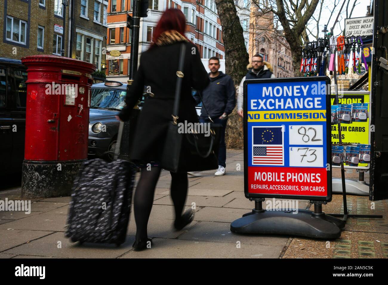 Euro and US Dollars exchange rates are displayed on a board outside a ...