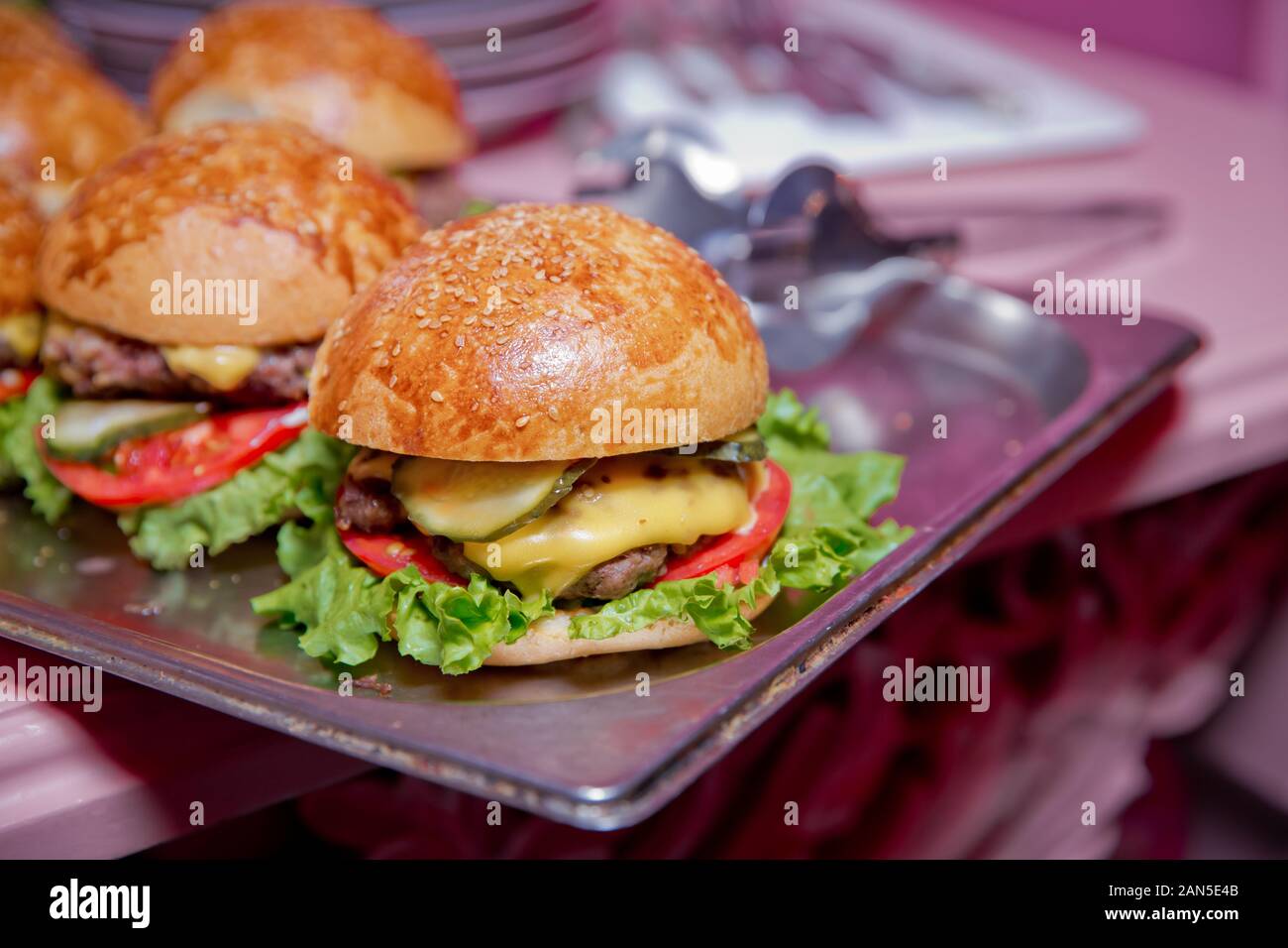Beautifully decorated catering banquet table with different hamburgers ...