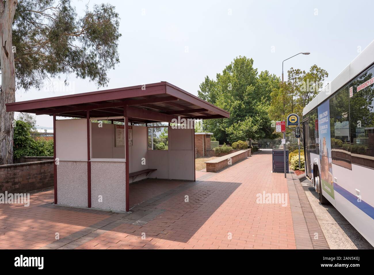 A lonely empty brick-built bus stop at the top of a staircase on the ...
