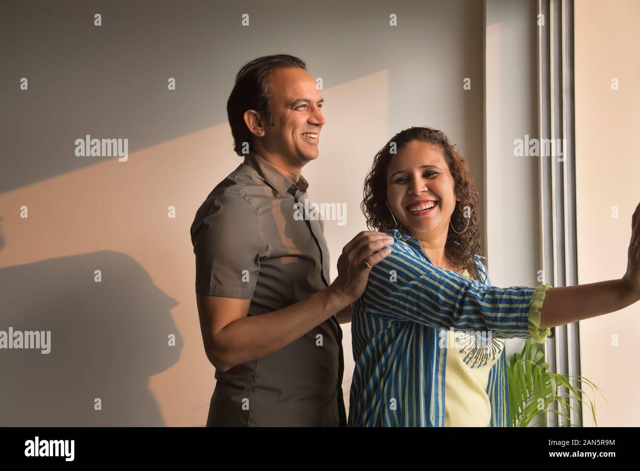 Couple standing together on the edge of the balcony at home Stock Photo ...