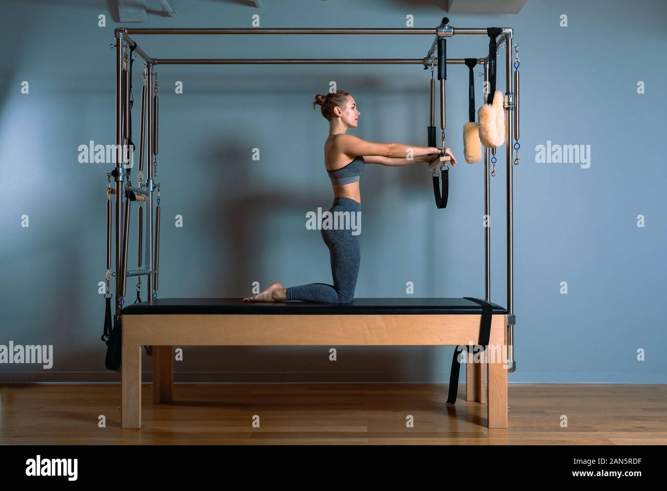 Pilates woman in reformer teaser exercise in gym indoors. Active ...