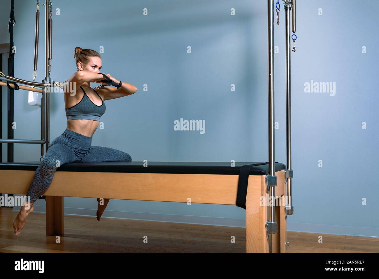 Pilates woman in reformer teaser exercise in gym indoors. Active ...