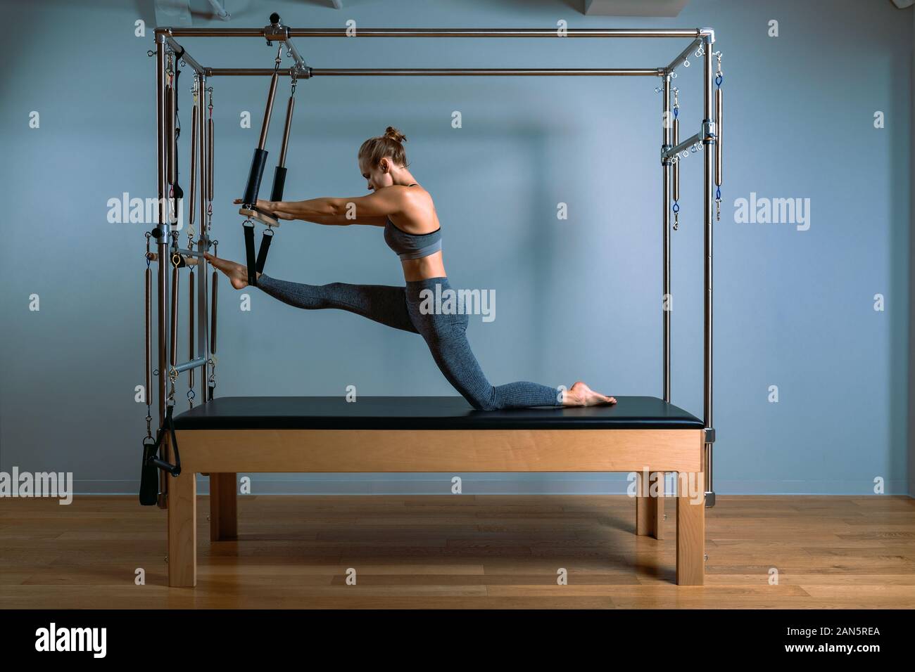 Pilates woman in reformer teaser exercise in gym indoors. Active ...