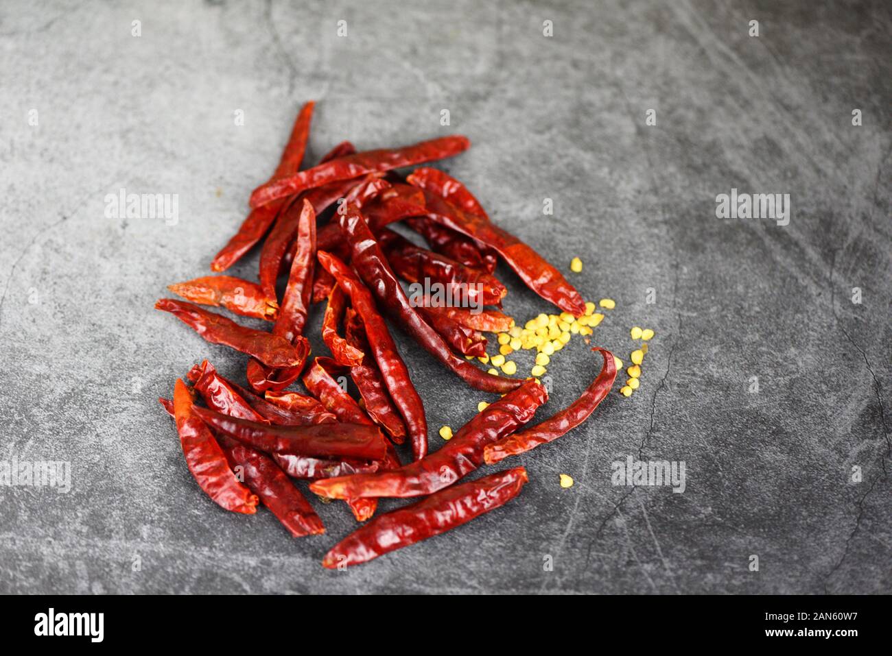 dried chillies on dark background / Red chili pepper seed Stock Photo ...