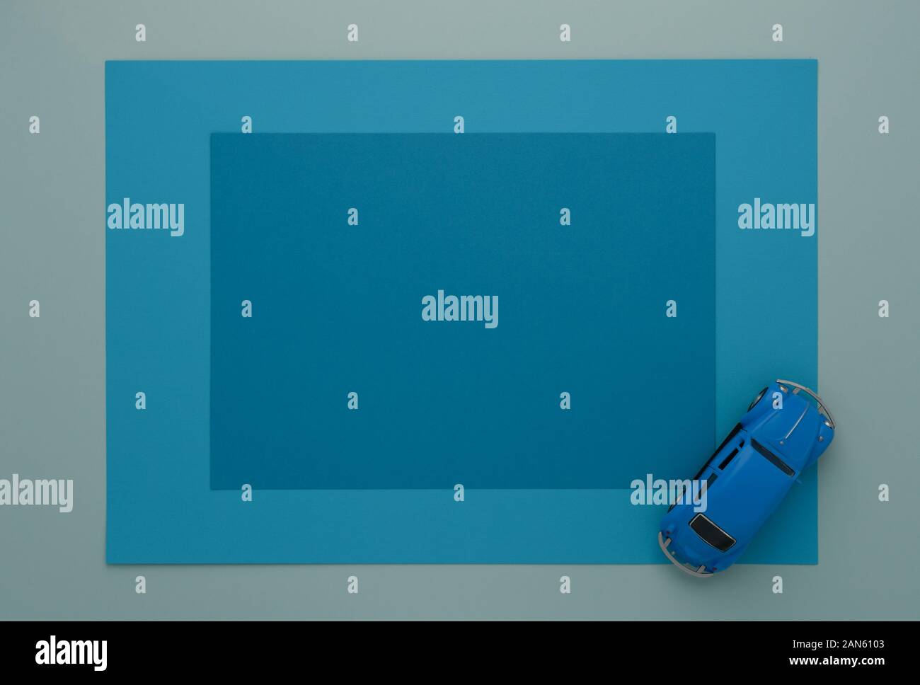 Little blue toy car on a frame of blue textured paper background Stock ...