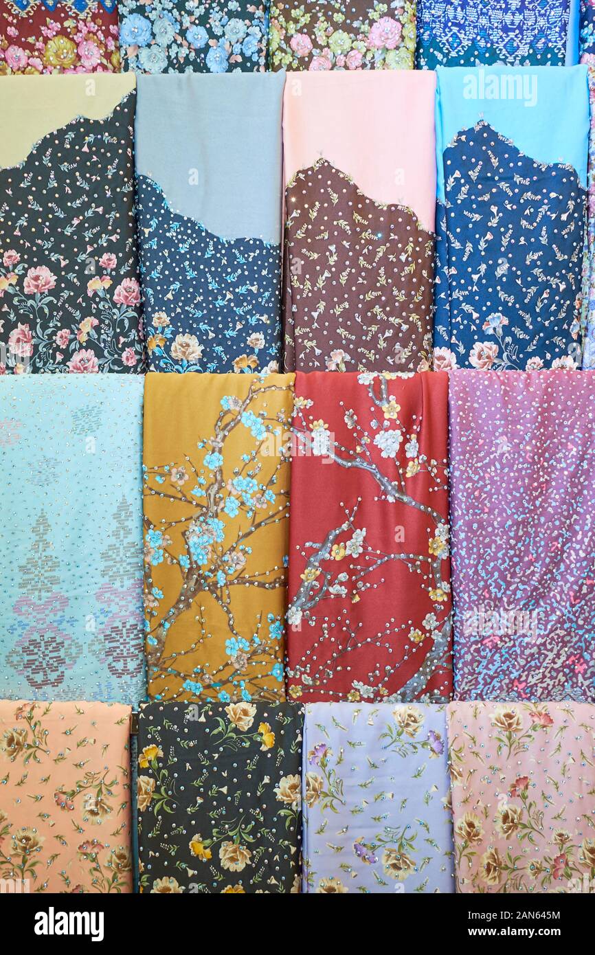 A display of colorful, traditional Malay floral design fabric, textiles ...