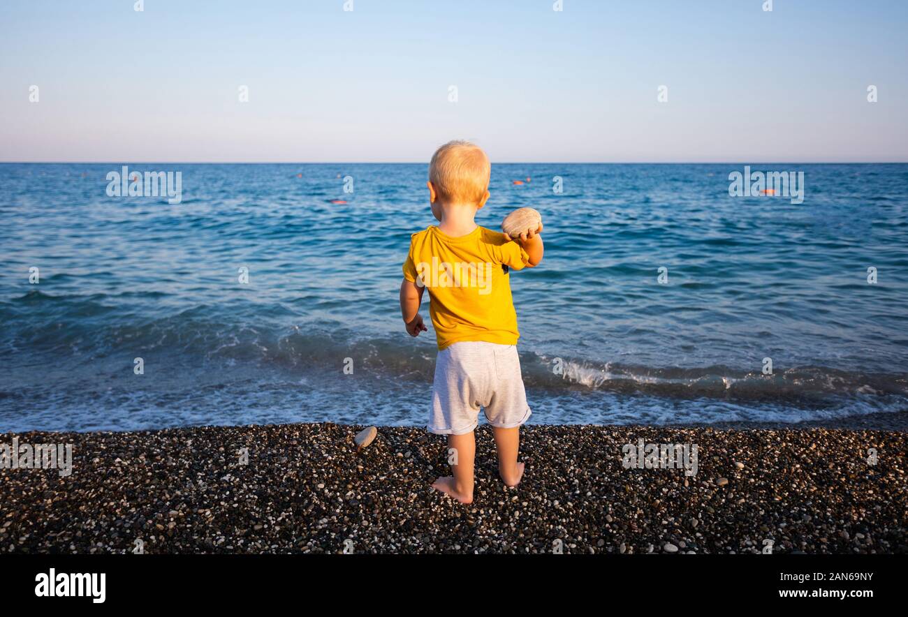 Boy throwing stone into water hi-res stock photography and images - Alamy