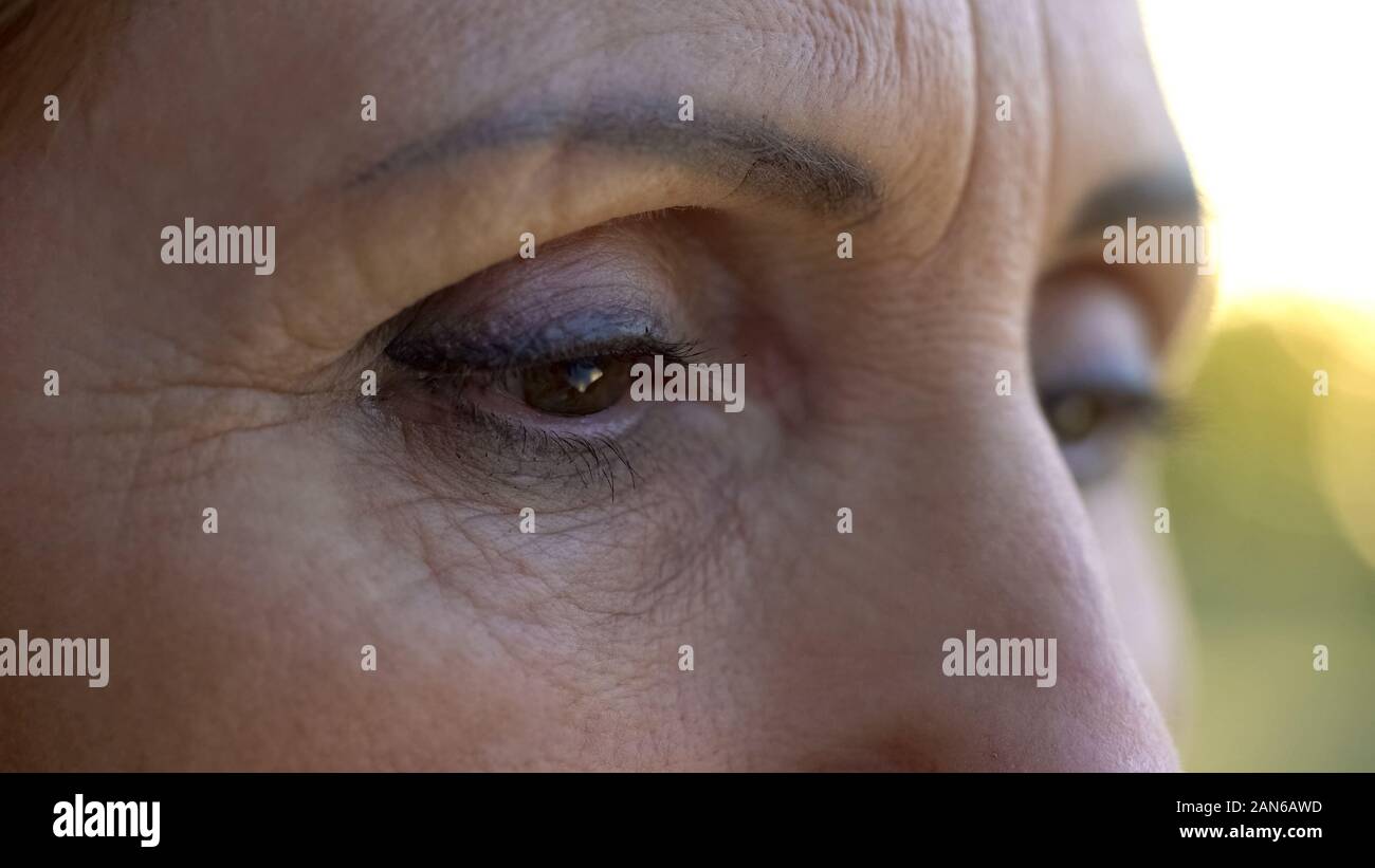 Upset woman looking down, regretting wrong decisions, ashamed, eyes ...