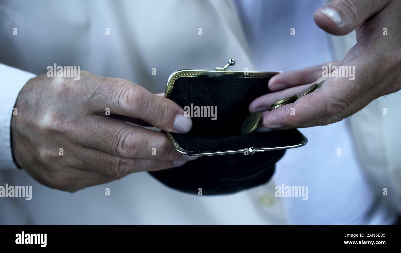 Old man with trembling hand putting coins in wallet, pensioner poverty ...