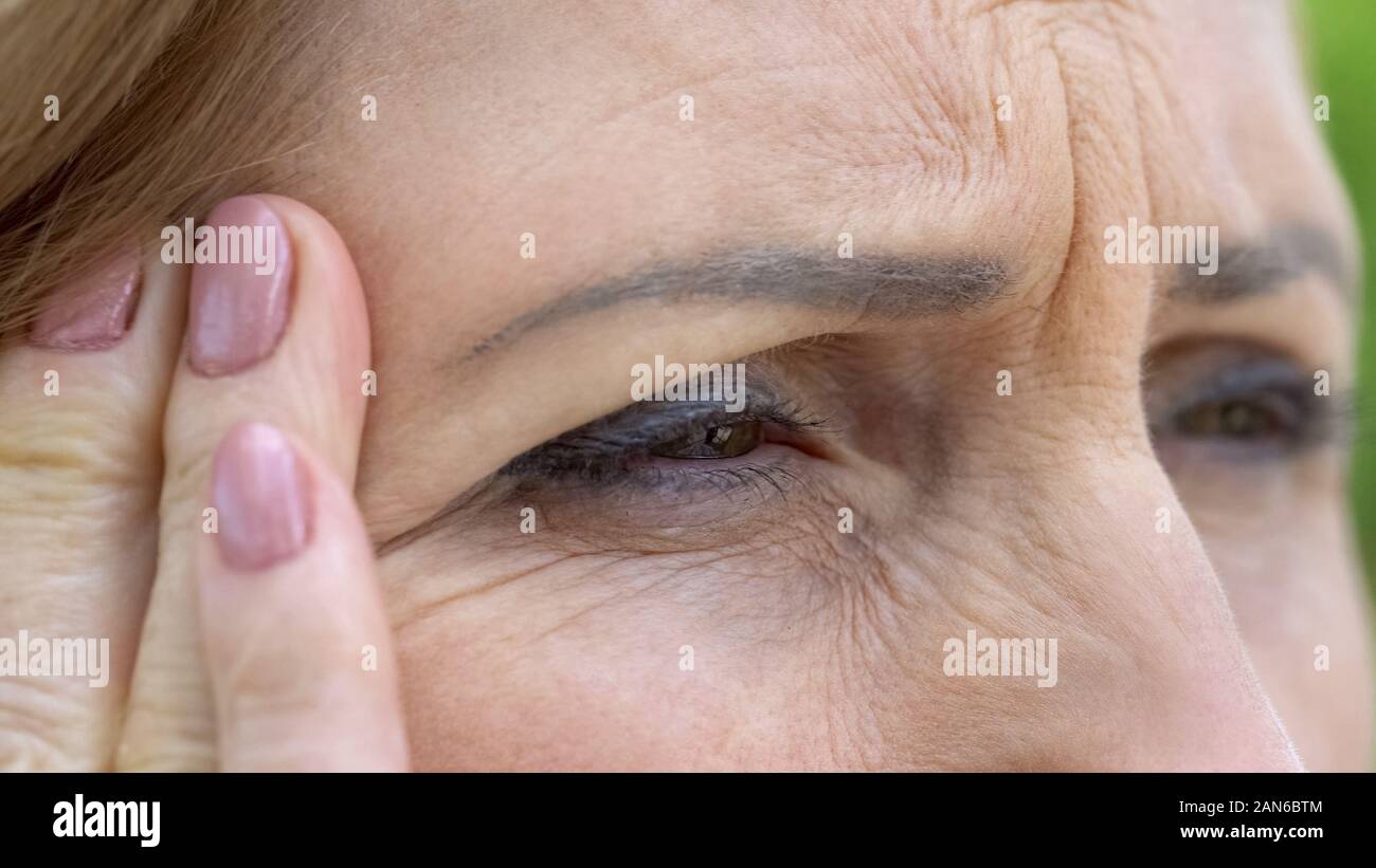 Senior woman suffering eyesight problems, cataract disease, vision ...