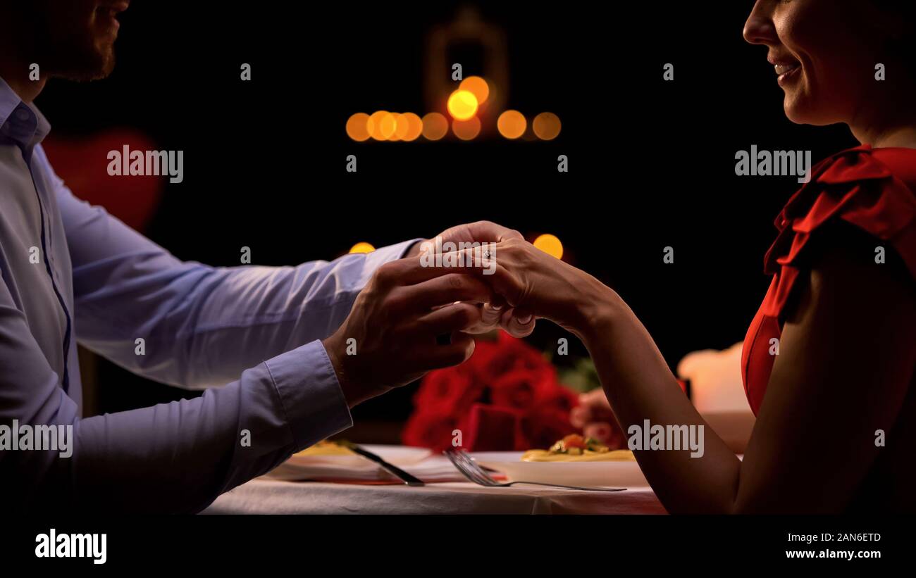 Boyfriend putting precious ring on female finger, couple enjoying ...