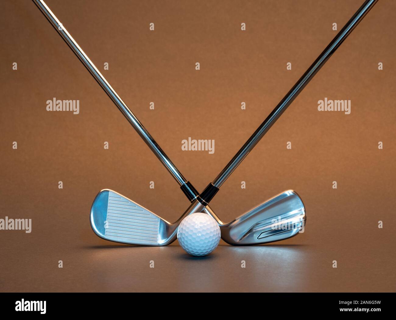 Two crossed golf clubs and golf ball in the middle Stock Photo - Alamy