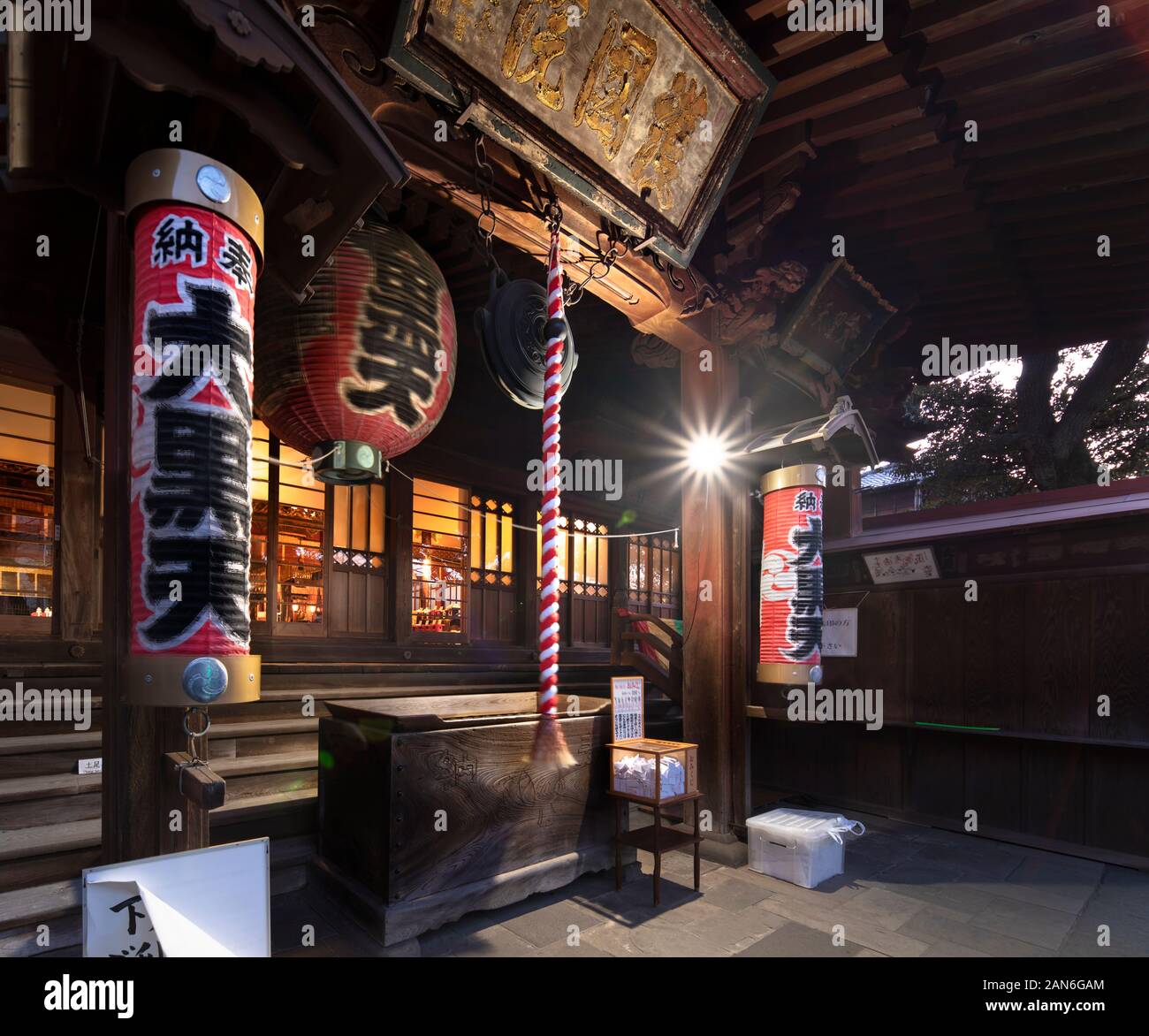 Entrance ornated with red paper lanterns and waniguchi gong of one of ...