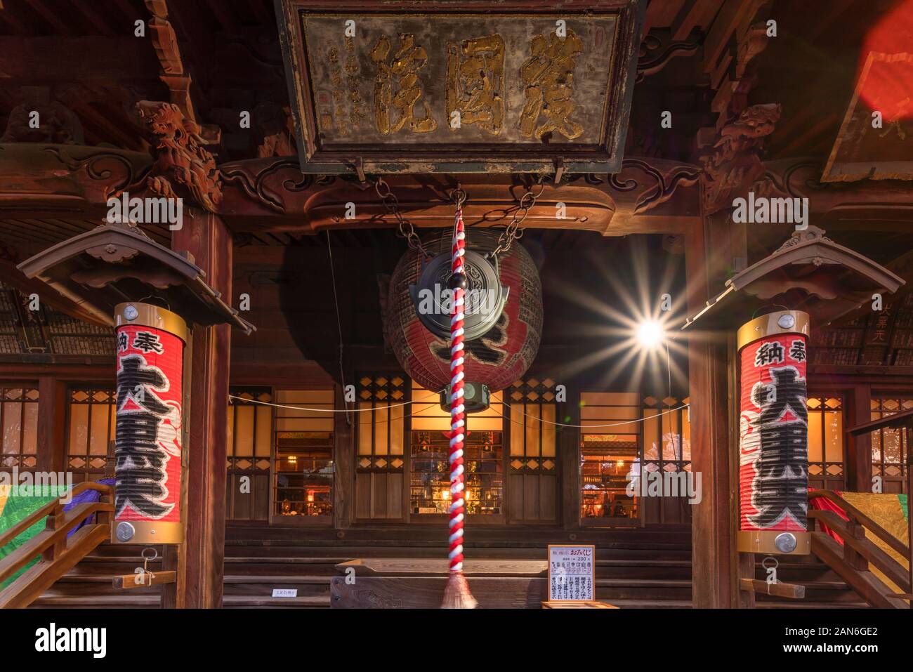 Entrance ornated with red paper lanterns and waniguchi gong of one of ...
