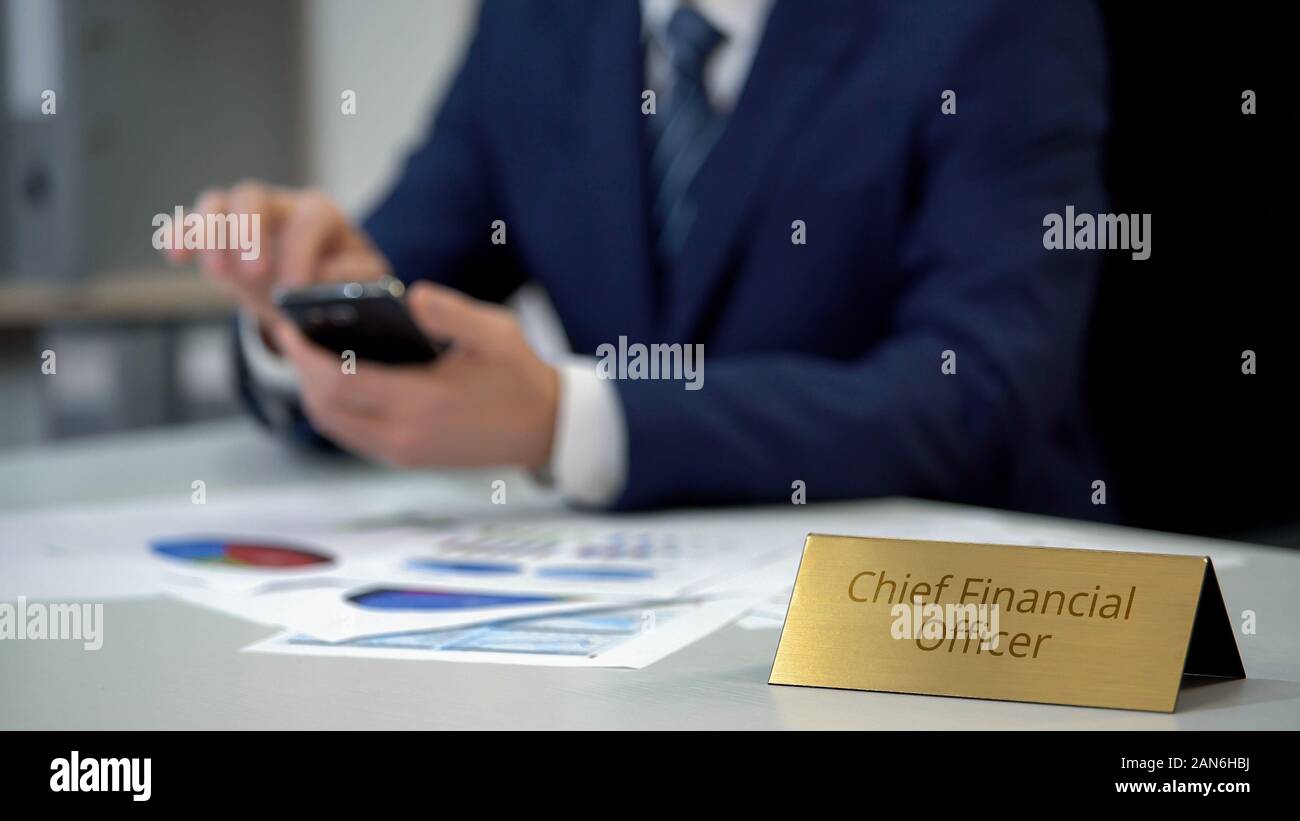 Busy chief financial officer of company using mobile app, working on ...