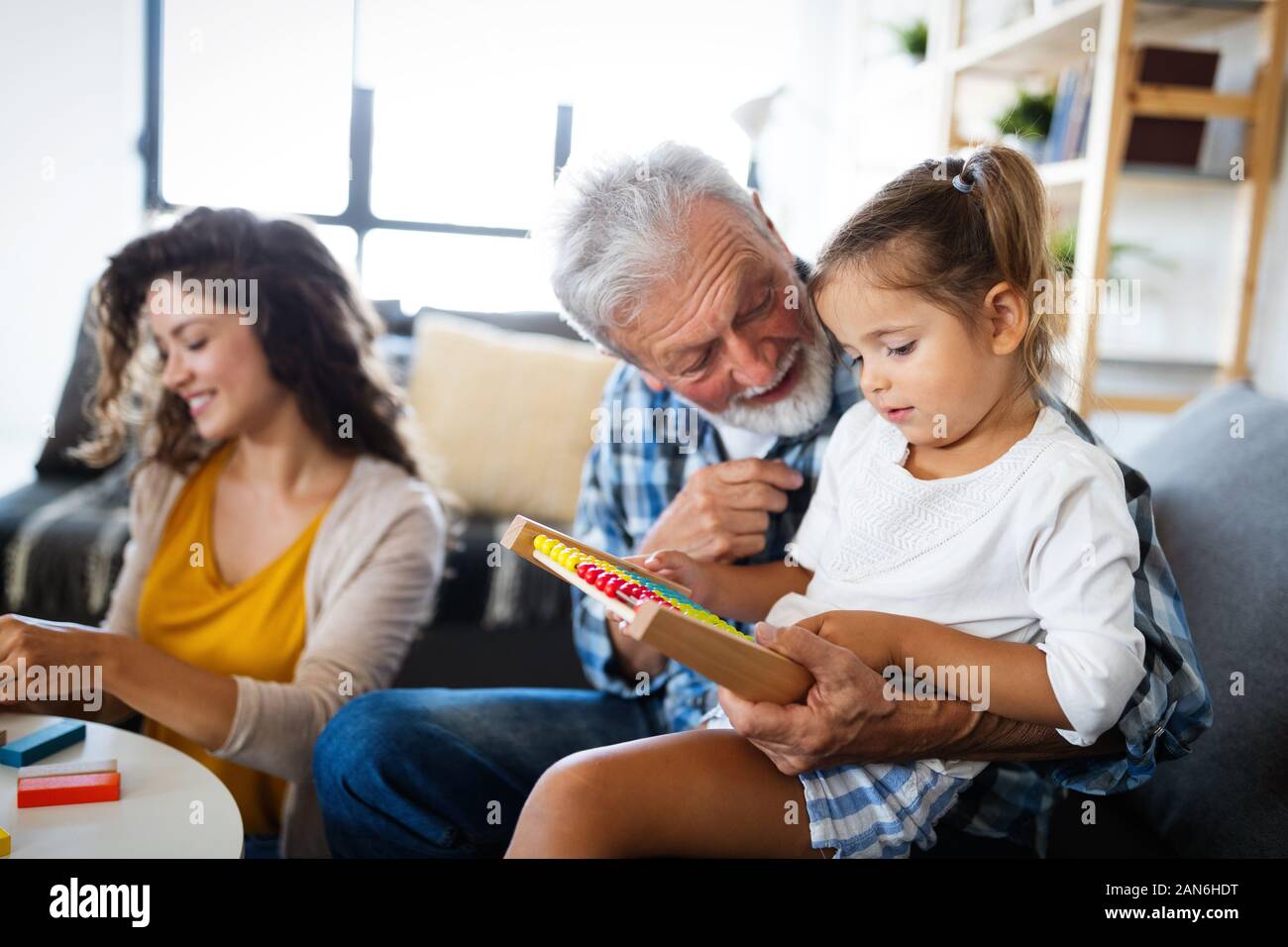 Happy family having fun time at home. Grandparent playing with children ...