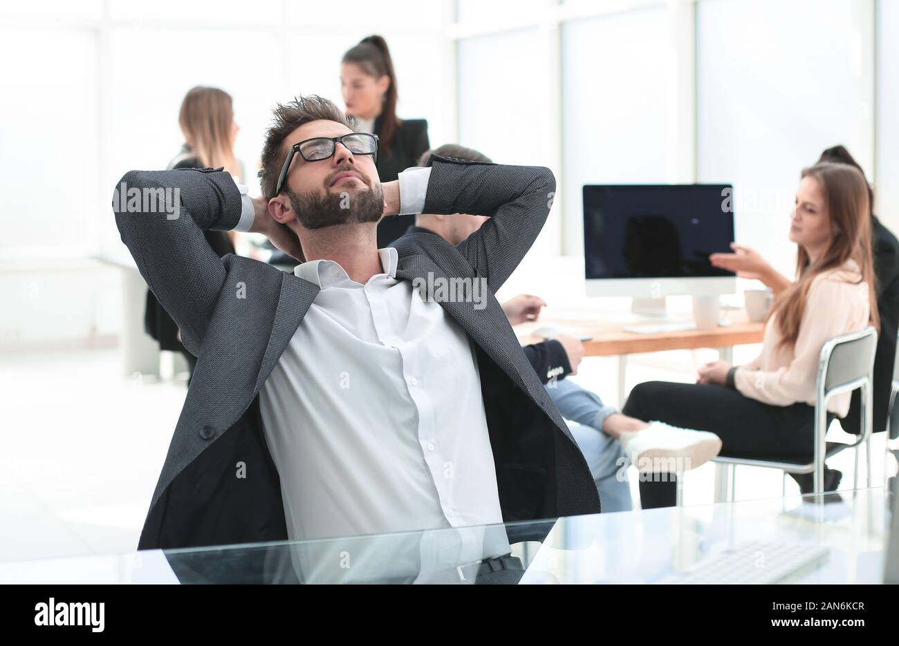 brooding young businessman sitting at an office Desk Stock Photo - Alamy