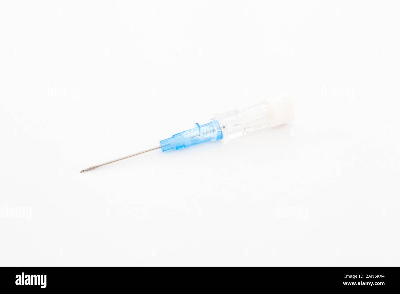 Medical blue needle isolated in white Stock Photo - Alamy
