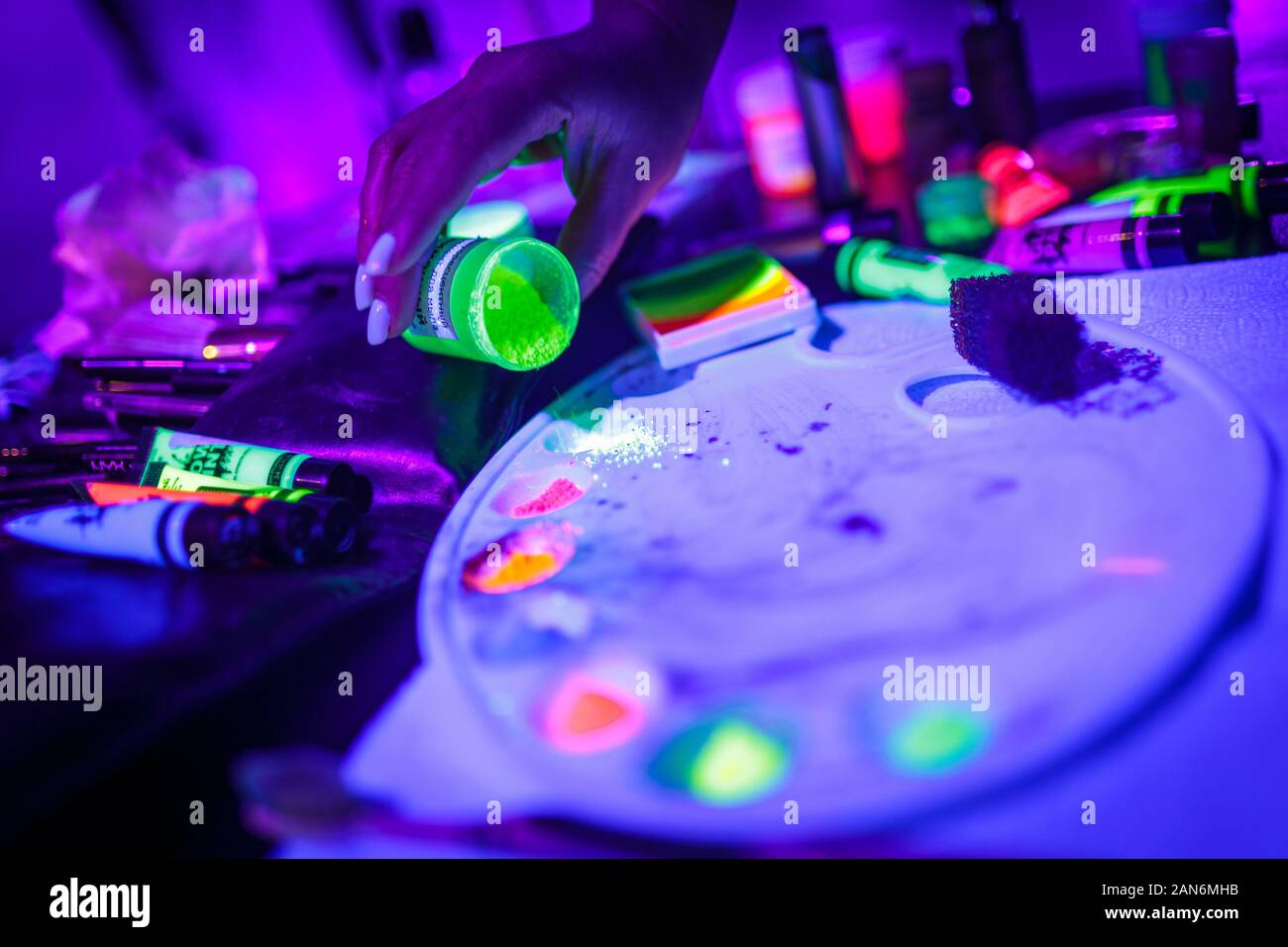 Multicolored UV fluorescent powder and paints on a palette Stock Photo ...