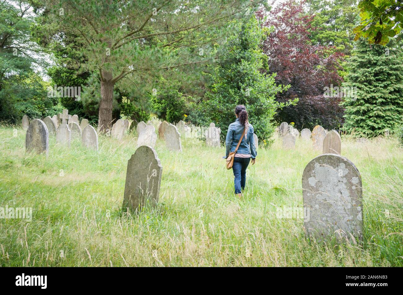Woman walking in cemetery hi-res stock photography and images - Alamy