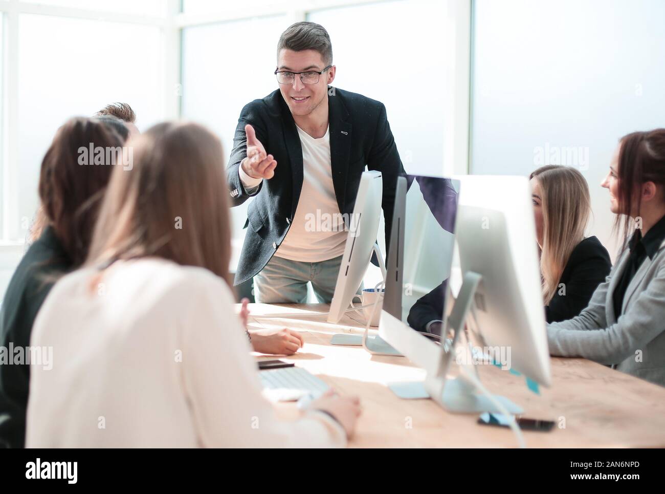 project Manager asks employees questions during the meeting Stock Photo ...