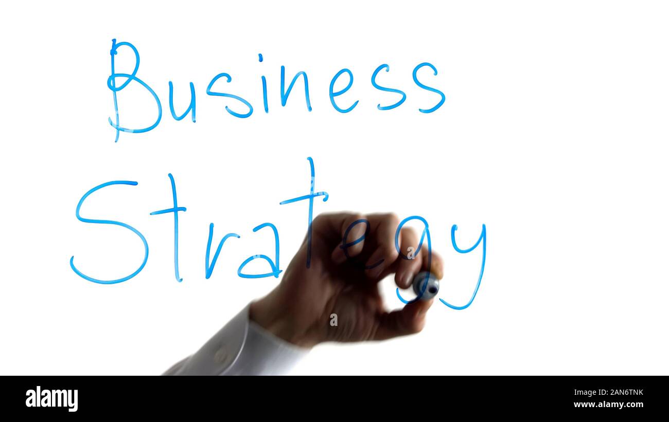Man writing business strategy phrase on white board, presentation ...