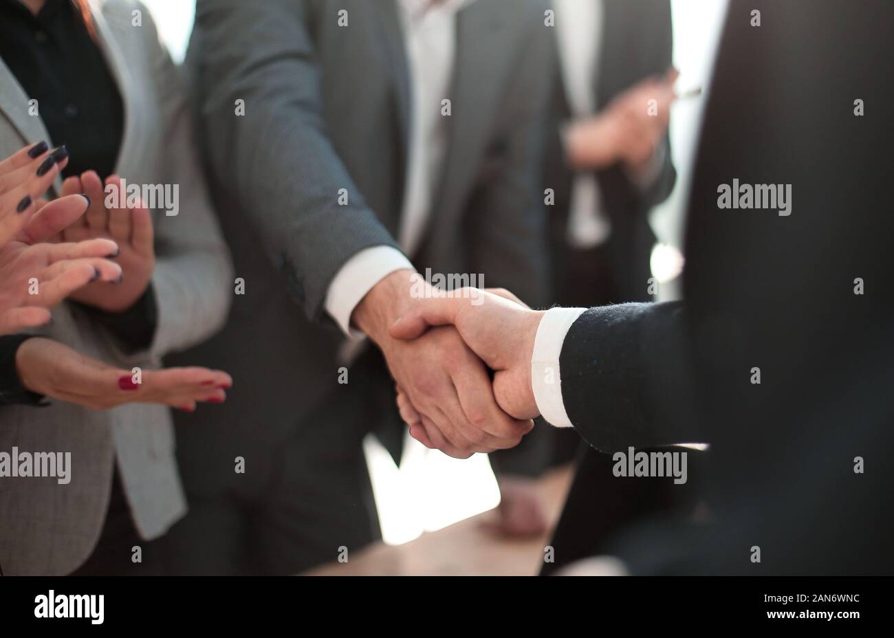 Standing leadership communication shaking hands smiling hi-res stock ...
