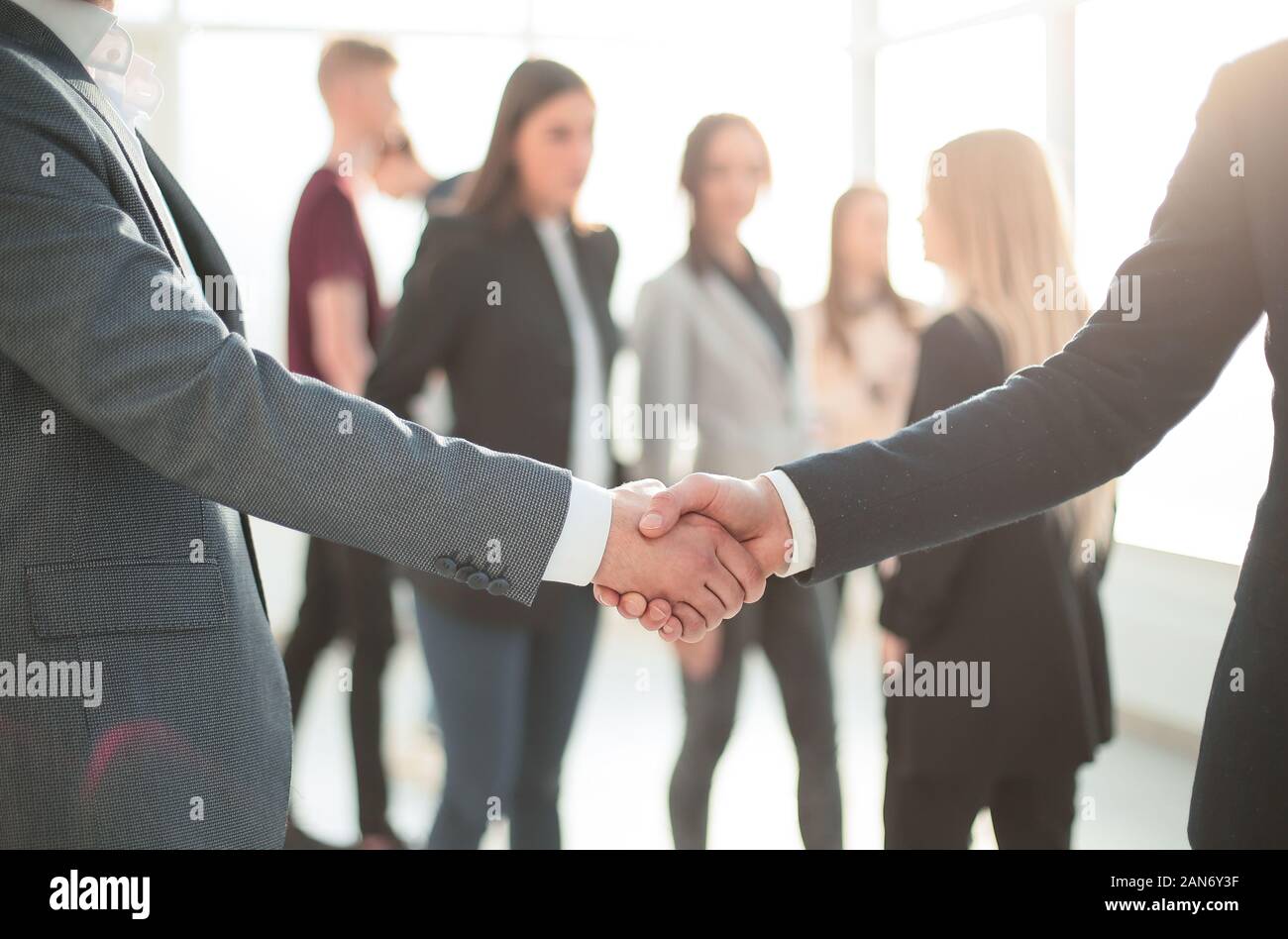 close up. strong handshake of business people on the office background ...