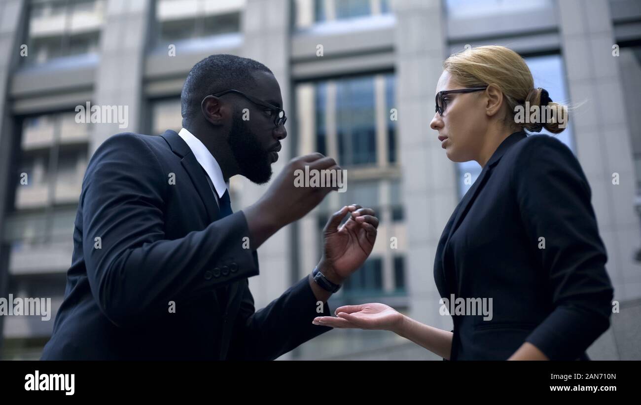 Manager criticizing female employee for mistake at work, stressful job ...