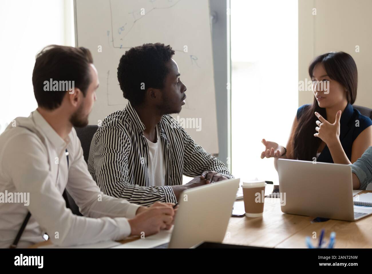 Multiethnic diverse employees brainstorm at meeting in office Stock ...