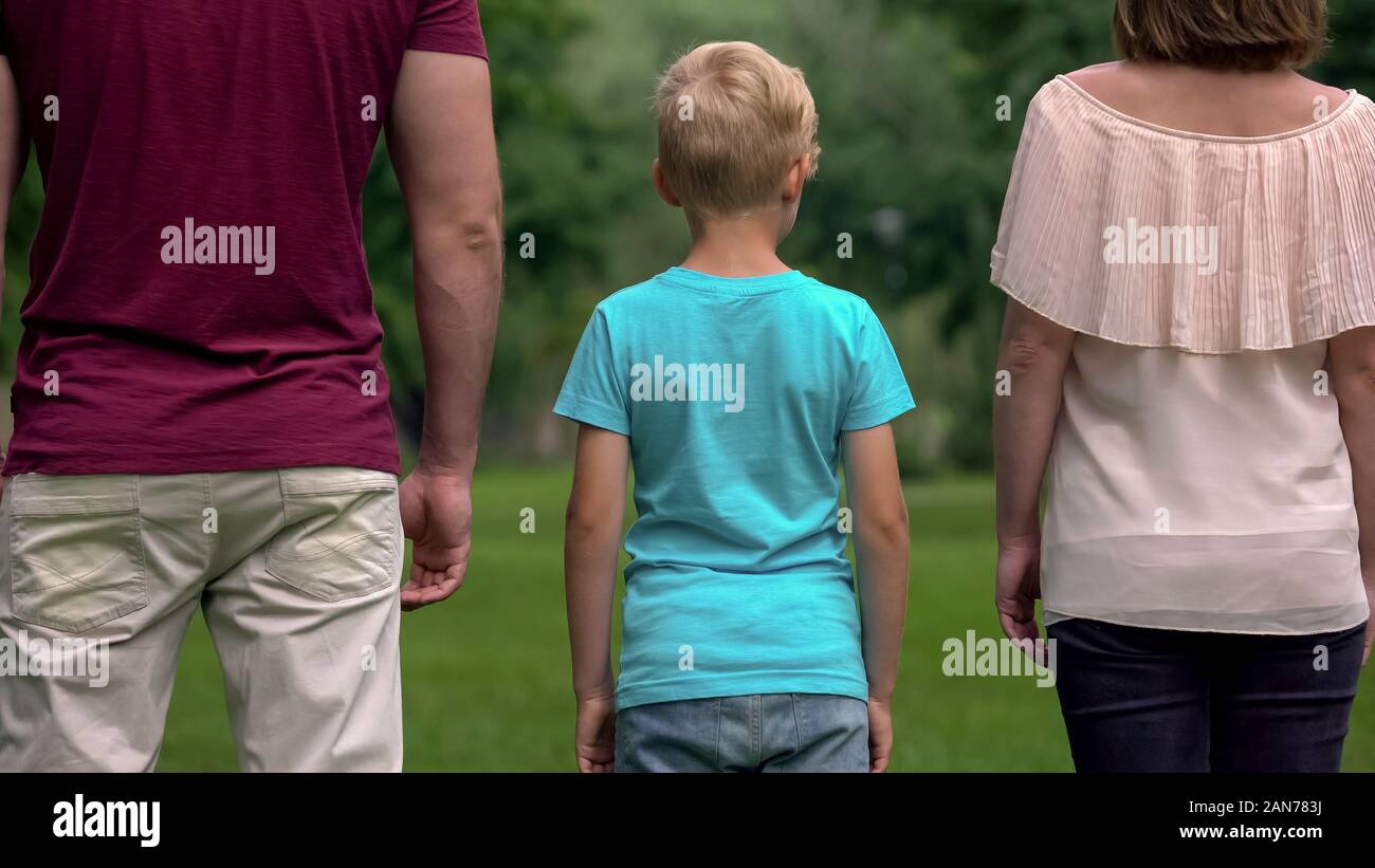 Back view of happy family looking forward, achieving goals together ...