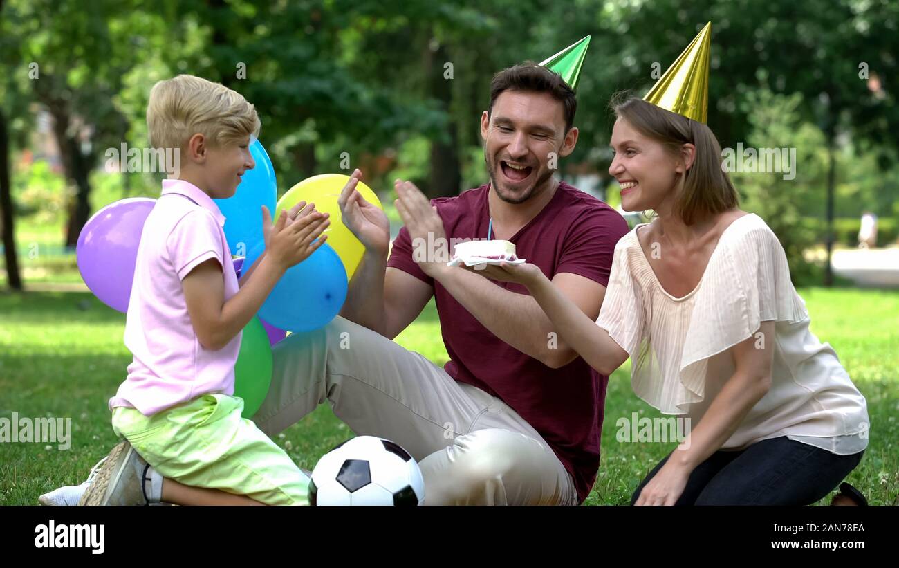 Parents congratulating son with birthday, party outside, unexpected ...