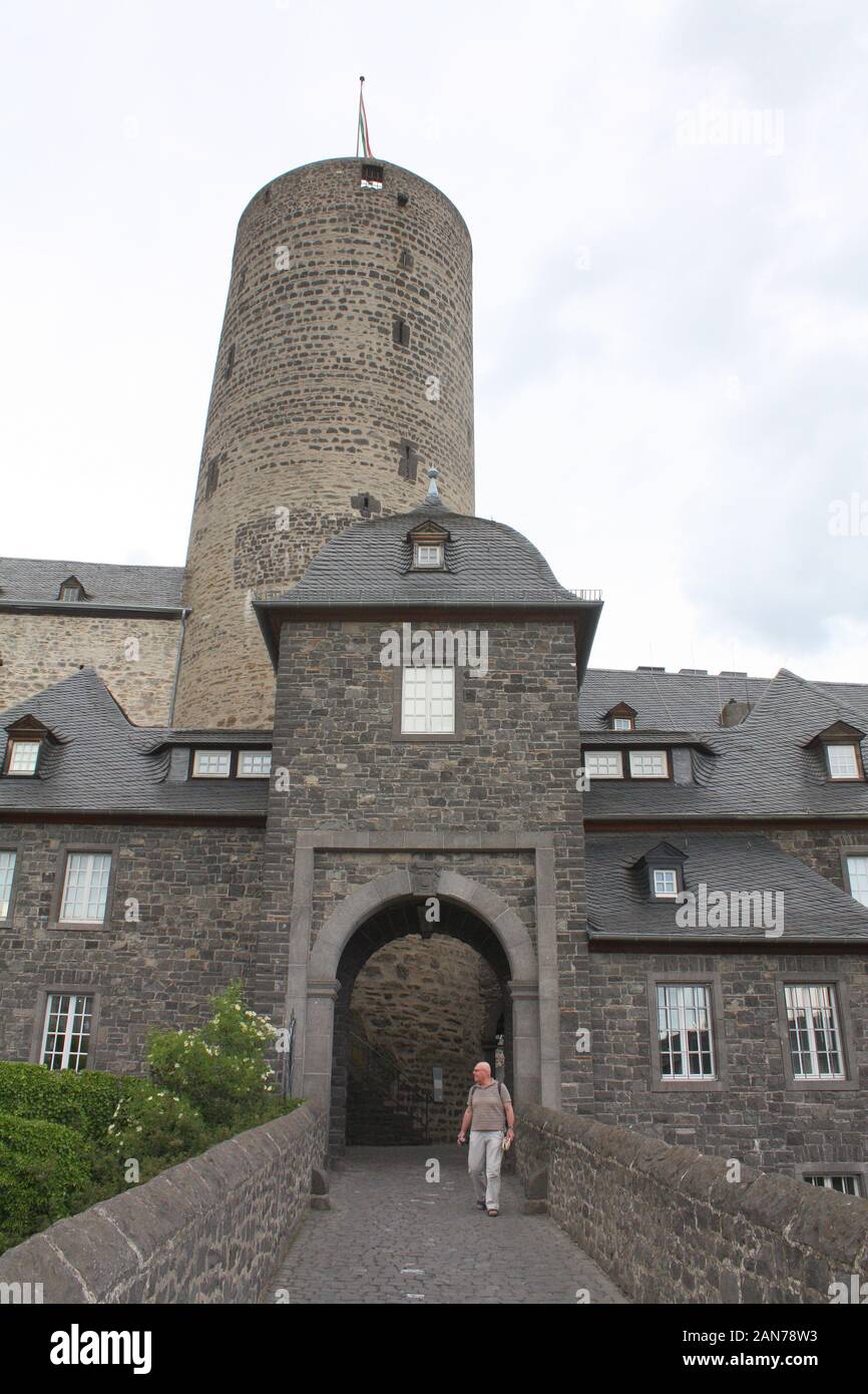 Tourist walks in to Genoveva Castle in Mayen. Germany Stock Photo - Alamy