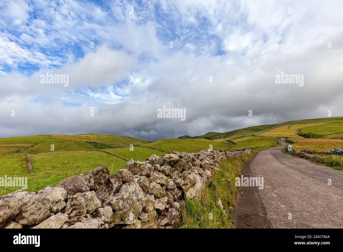 Rock wall and road in the northern area of Flores island in the Azores ...