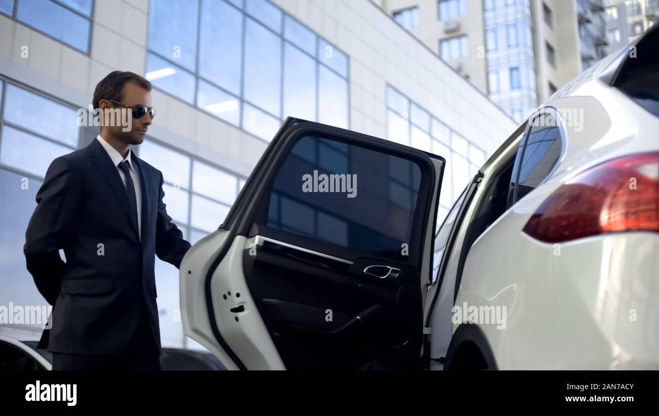 Doorman opening door hi-res stock photography and images - Alamy