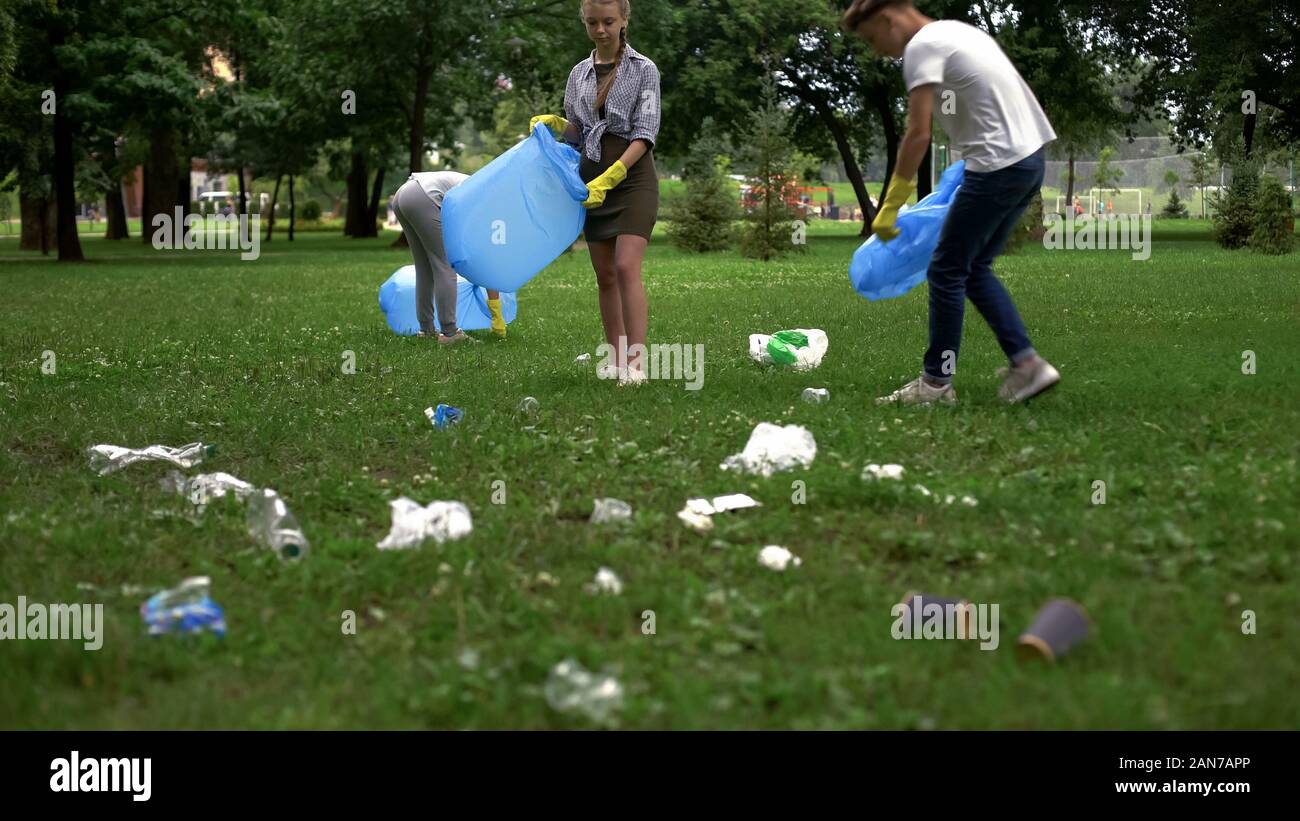 Active citizens collecting garbage in public park, society against ...