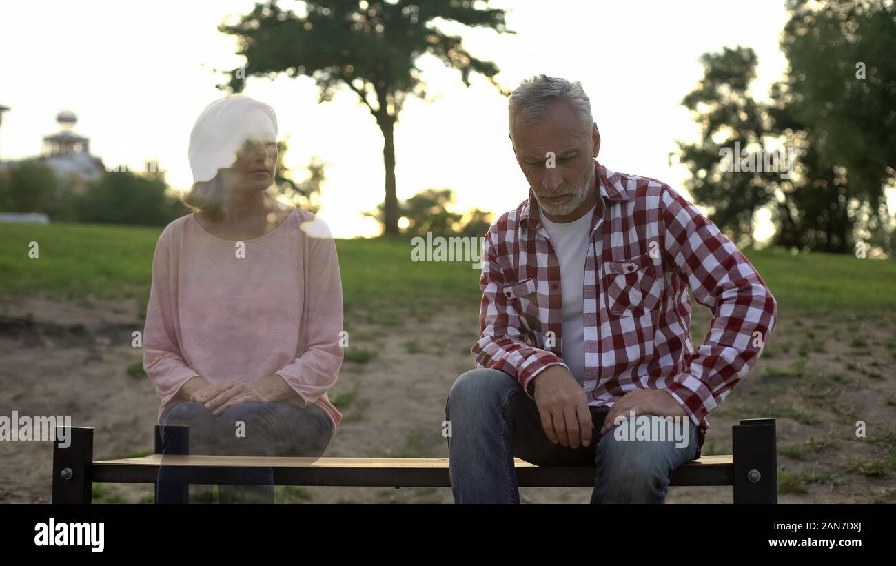 Depressed old man sitting on bench, wife appearing beside, loss sorrow ...