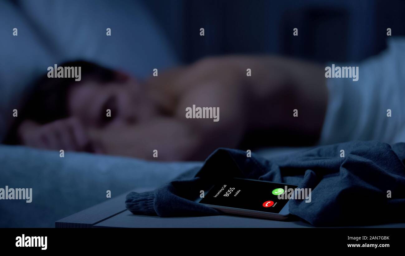 Boss calling, tired after hard work day man sleeping in bed, business ...