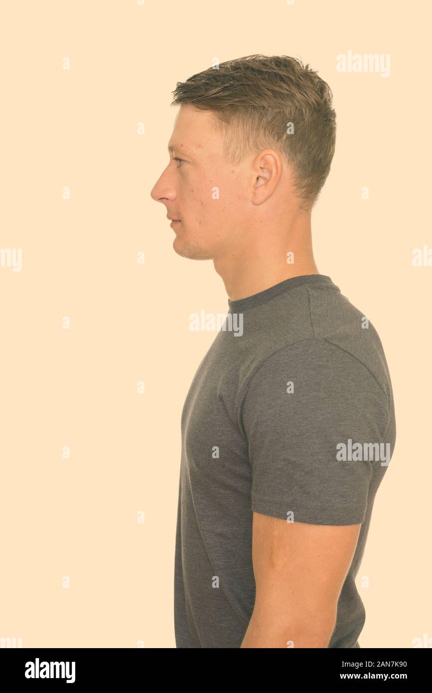 Side view of young handsome Caucasian man isolated against white ...