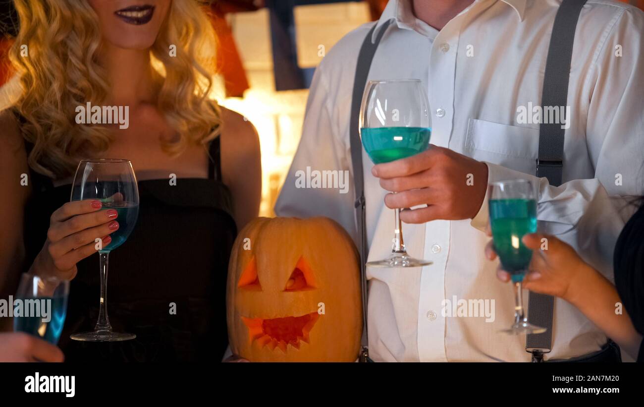 Group of people having fun at Halloween party with pumpkin and blue ...