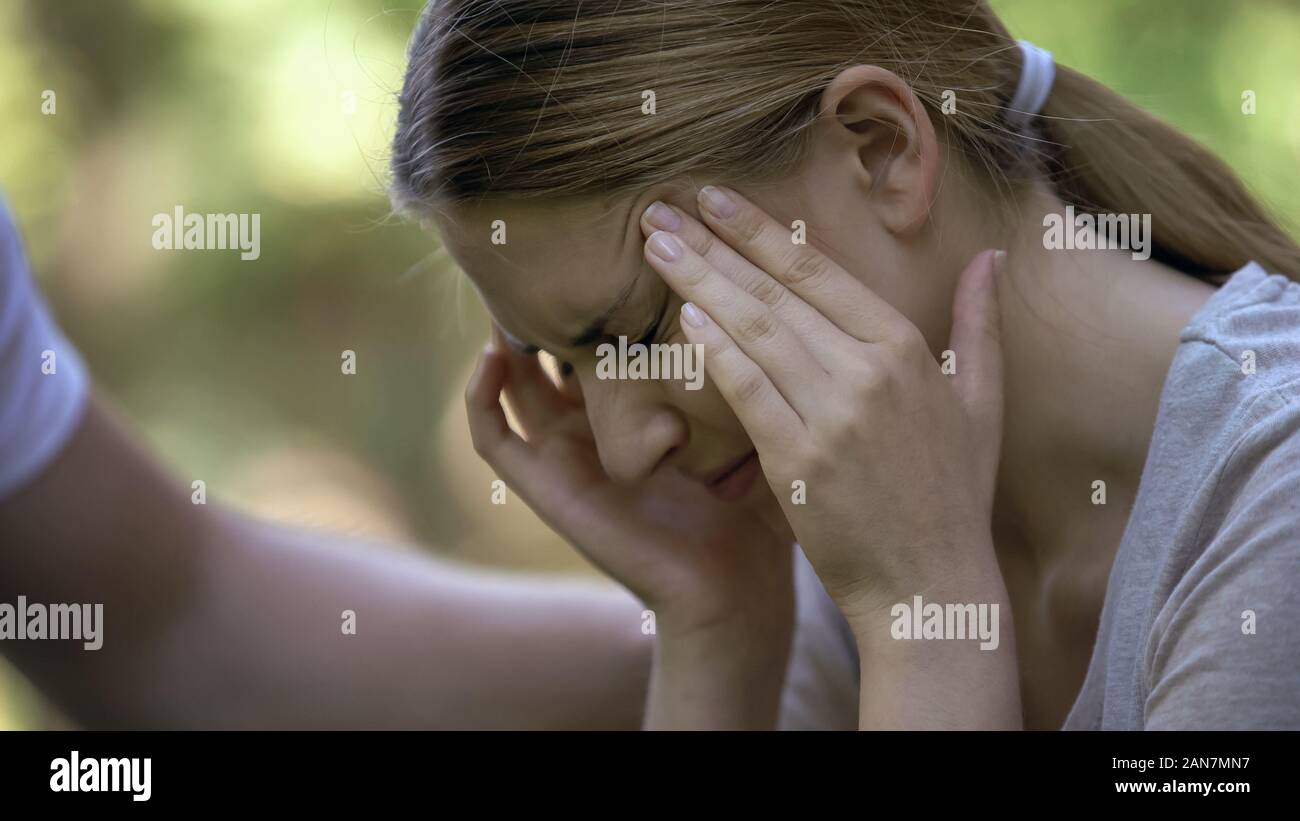 Girl suffering acute headache, worrying about failures, male hand ...