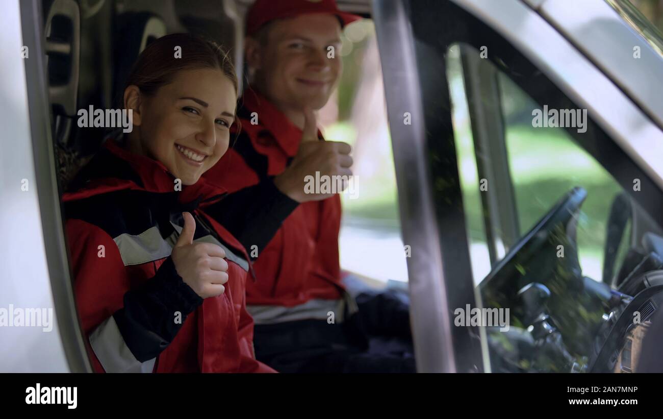 Ambulance crew showing thumbs up, professionals on duty provide first ...
