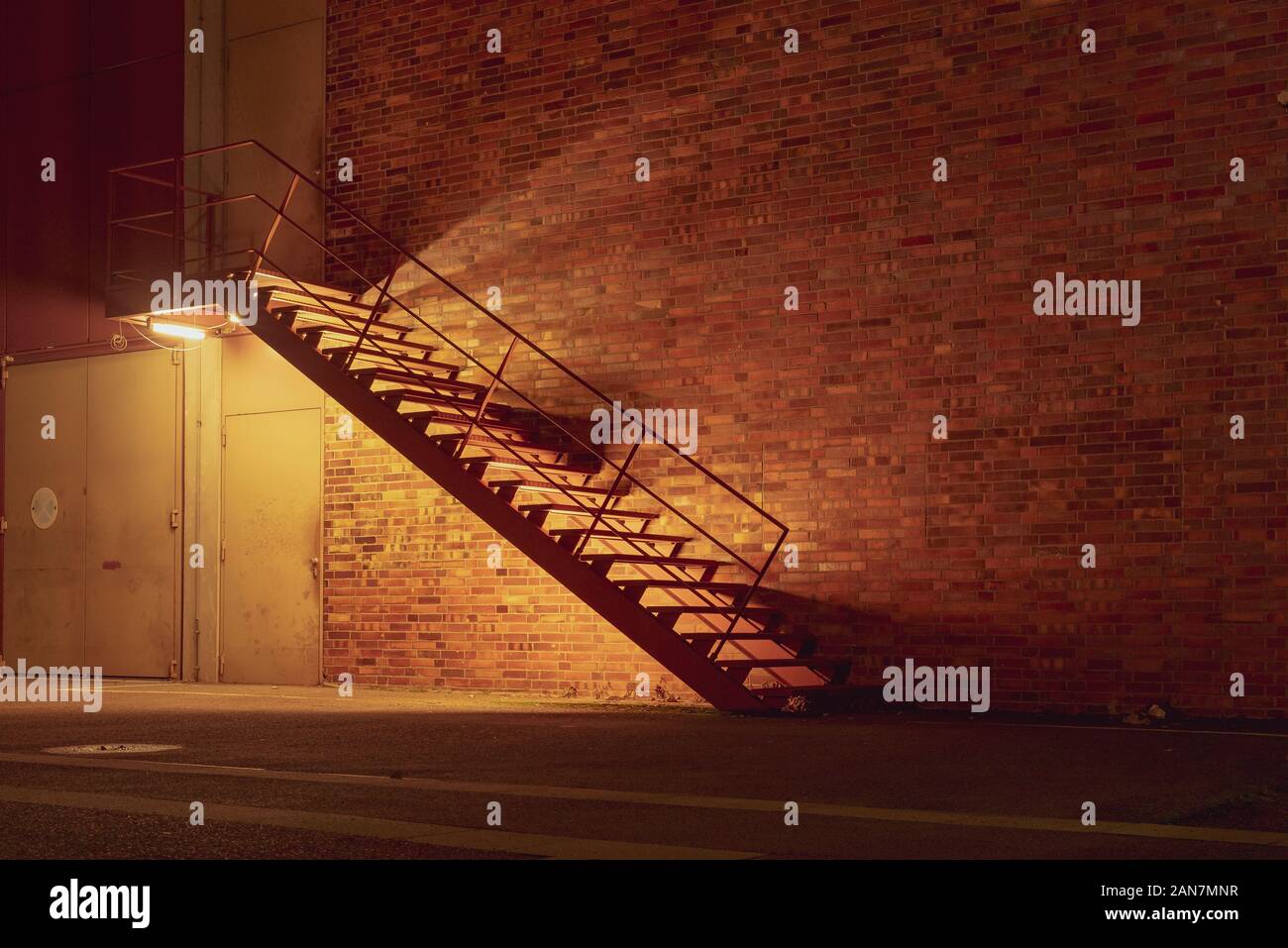 illuminated metal stair at night, simple stairway at night, warm ...