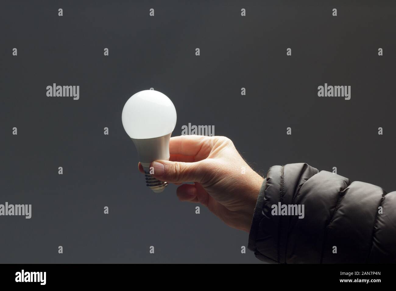 Energy saving daylight bulb, in the hand of an adult; bulb prepared to ...