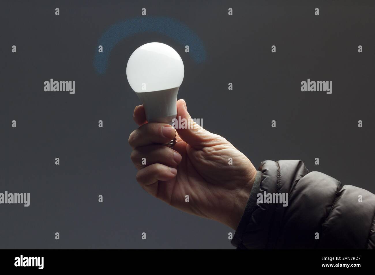 Energy saving daylight bulb, in the hand of an adult; bulb prepared to ...