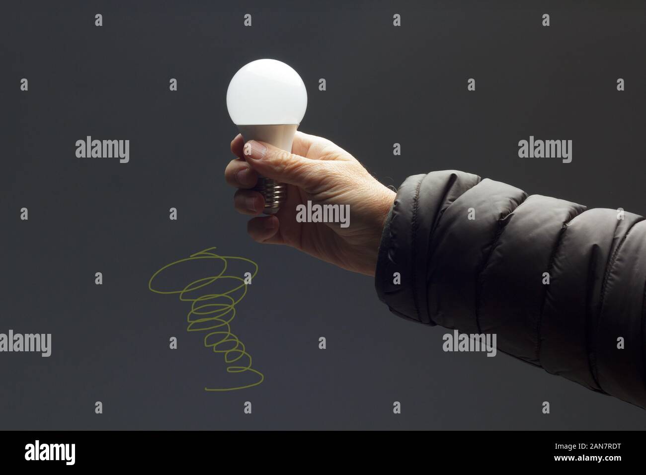 Energy saving daylight bulb, in the hand of an adult; bulb prepared to ...