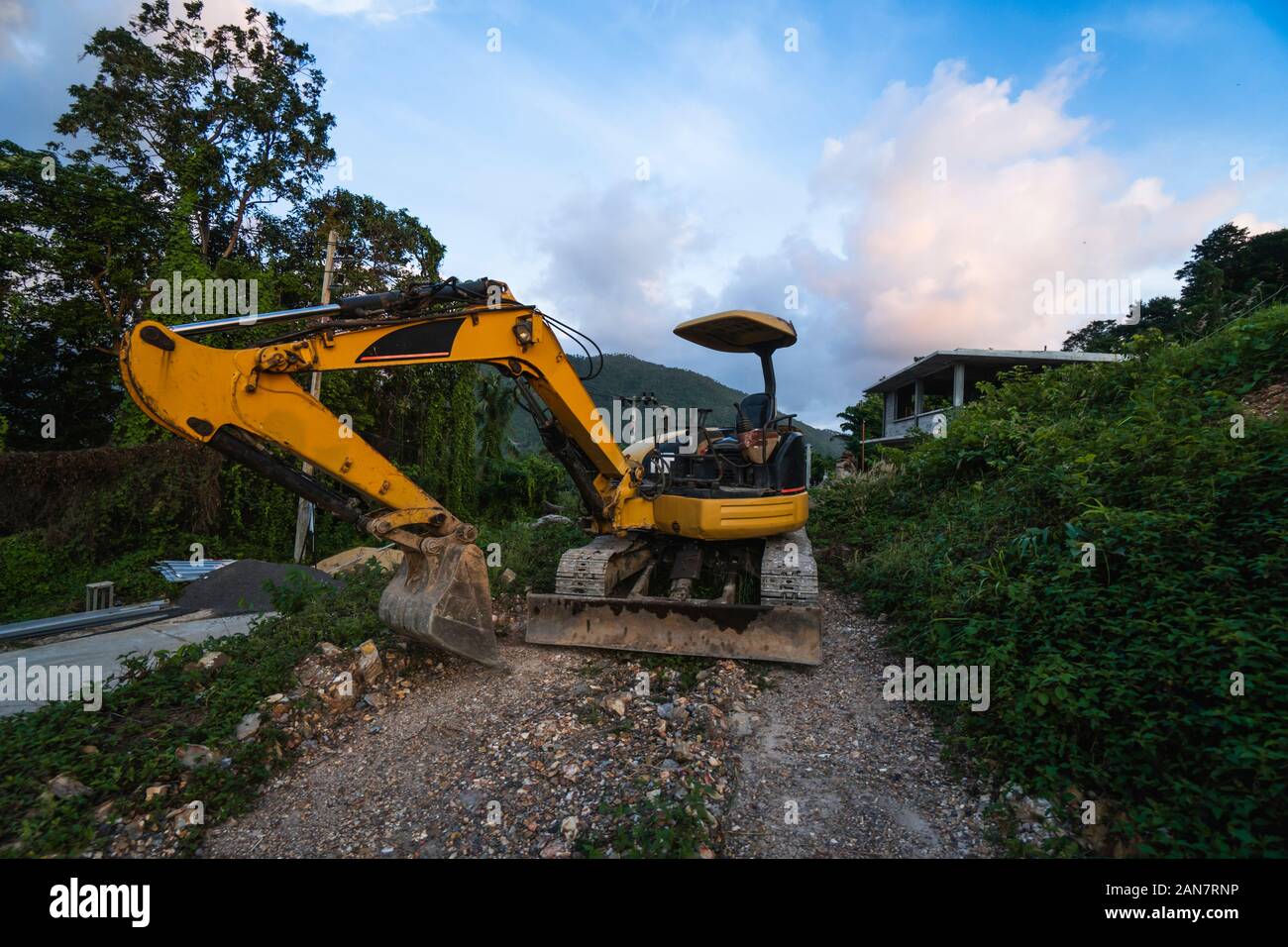 The modern excavator on the construction site with sunset sky. Large ...