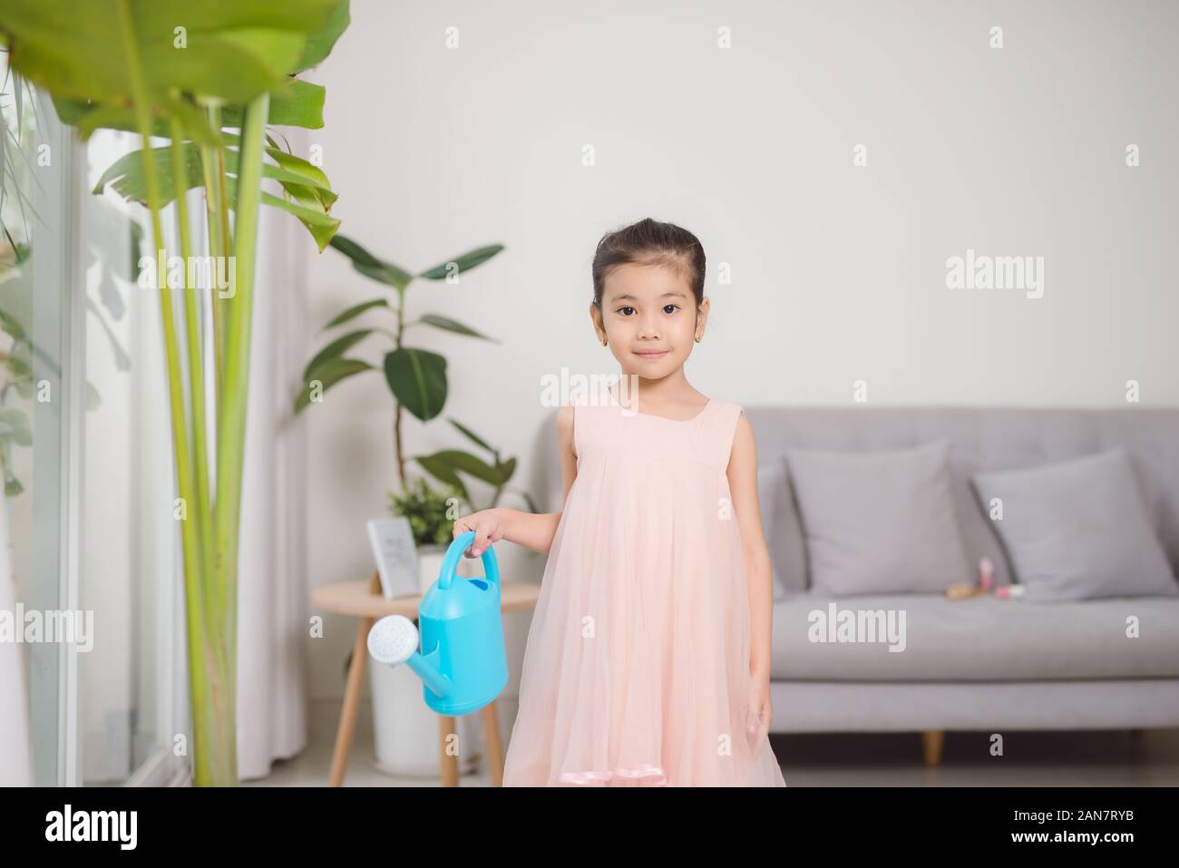 Cute girl care for plants Stock Photo - Alamy
