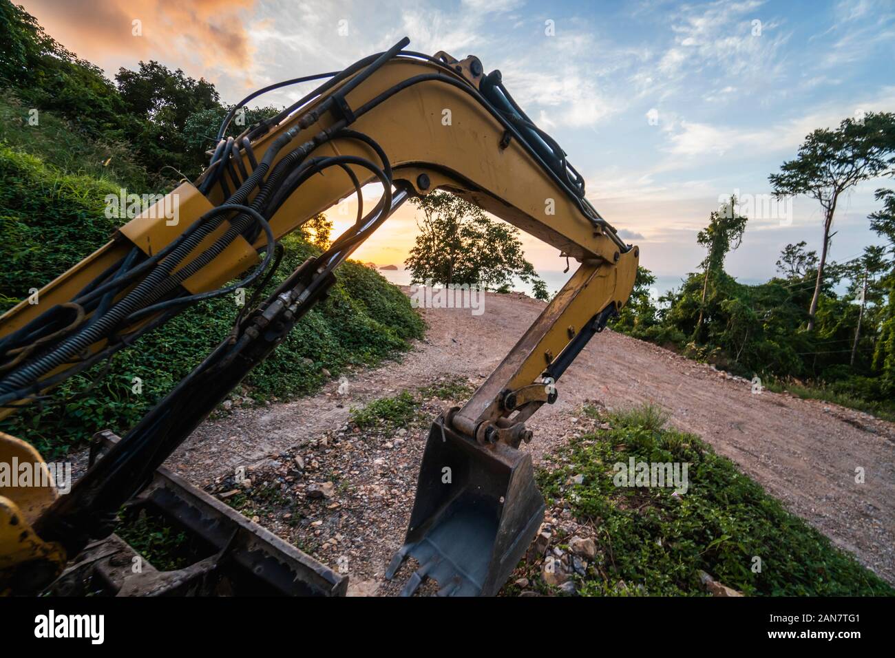 Details of modern excavator on the construction site with sunset sky ...